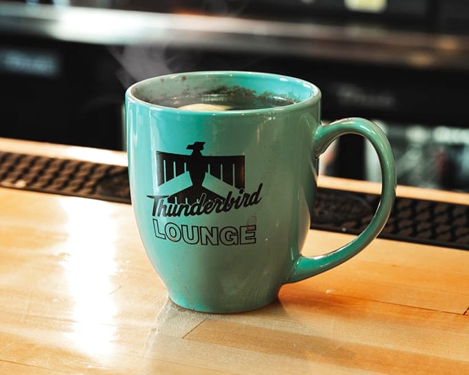 The Thunderbird mug holds hot beverages with the same retro flair that defines every corner of this establishment.