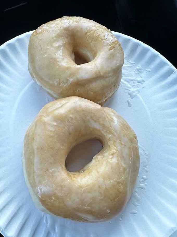 Two perfect glazed donuts that need no introduction, no explanation, and definitely no sharing with anyone else.