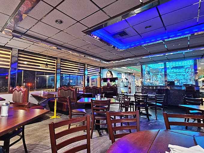 Blue neon overhead transforms this dining room into something between retro cool and modern chic, absolutely nailing it.