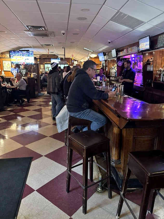 The bar fills with locals who know good ribs when they taste them, creating that perfect tavern buzz.