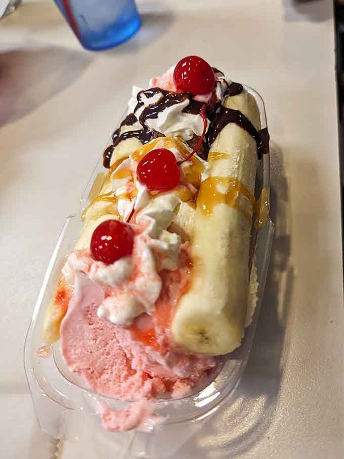This banana split is a masterpiece of ice cream engineering topped with whipped cream and cherries.