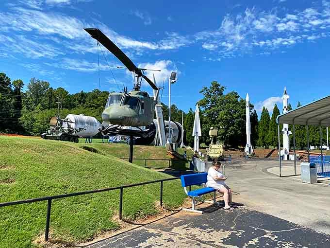 Where else can you casually stroll past a Huey helicopter while contemplating rockets like you're shopping for groceries?