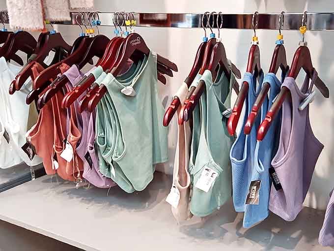 Tank tops arranged by color because even casual wear deserves to look like it has its life together.