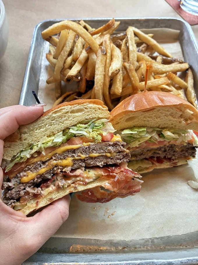 Two beef patties, American cheese, and classic toppings deliver straightforward burger perfection without unnecessary complications.