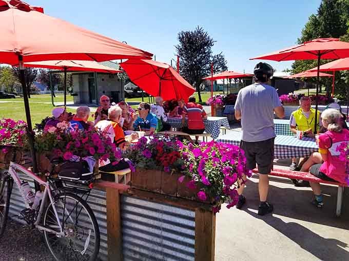 Outdoor seating under bright umbrellas where strangers become friends over shared appreciation for excellent food.