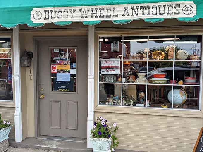 Buggy Wheel Antiques displays its wares with the kind of eclectic charm that makes every window worth studying.