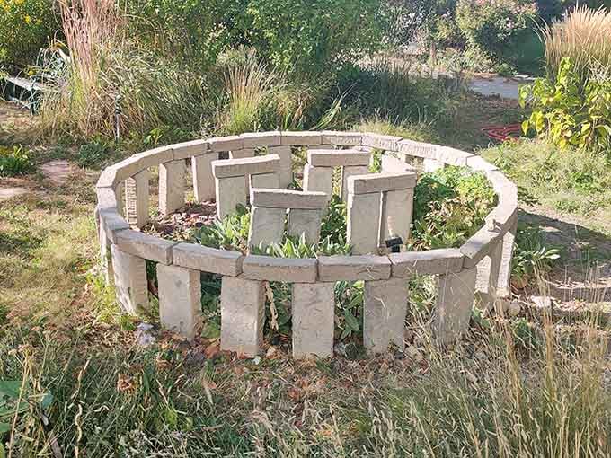 This circular stone structure looks like a miniature Stonehenge designed by gardeners instead of ancient druids.