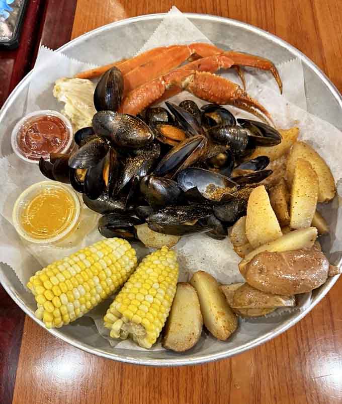 A seafood boil piled high with crab legs, mussels, corn, and potatoes: dinner and a workout combined beautifully.