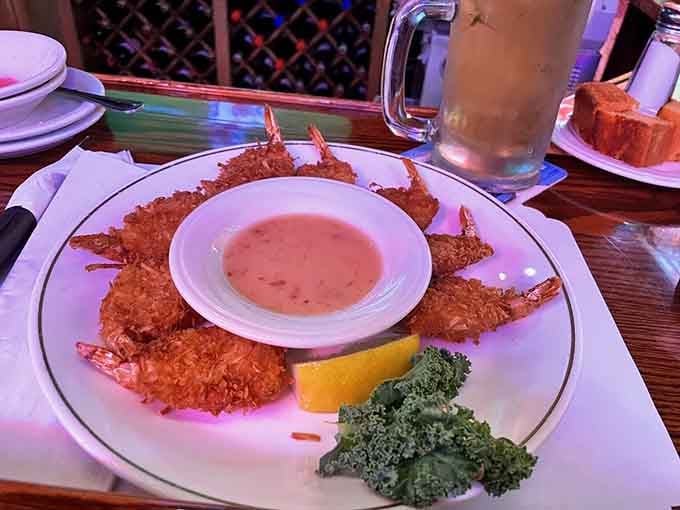 Coconut shrimp arrives golden and crispy, proving that even the appetizers here understand the assignment and deliver beautifully.