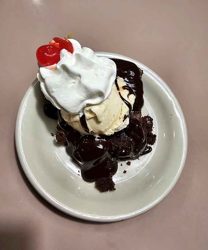 Hot fudge brownie sundae topped with whipped cream and a cherry, because sometimes dessert needs to be gloriously over the top.