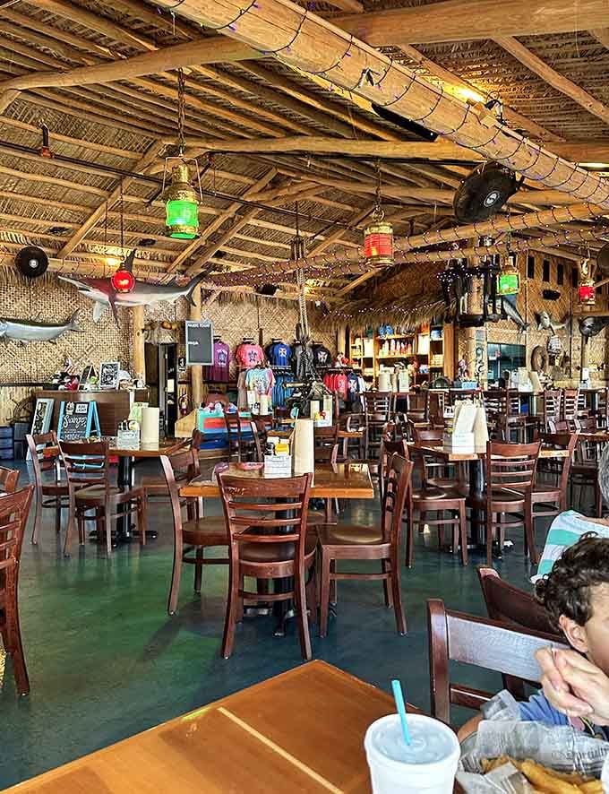 Dining under string lights with fish sculptures overhead creates that perfect blend of whimsy and waterfront sophistication you didn't know you needed.