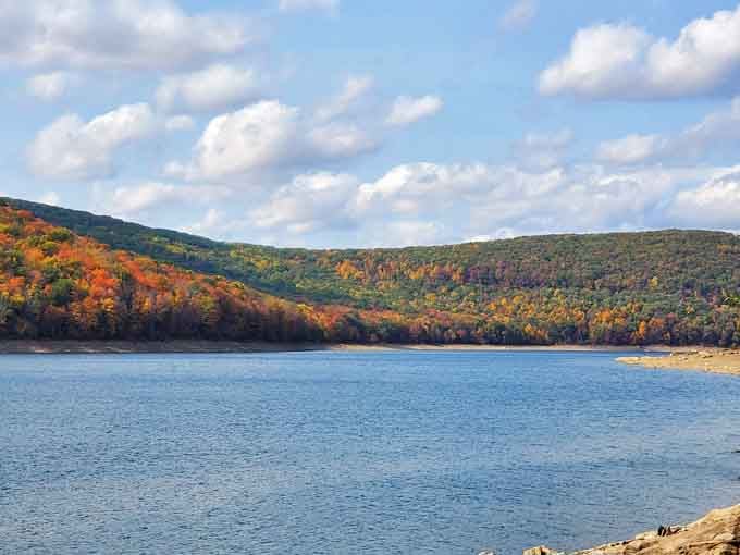 Autumn paints the hillsides in brilliant orange and gold above the reservoir, creating a scene worthy of any landscape painter's canvas.