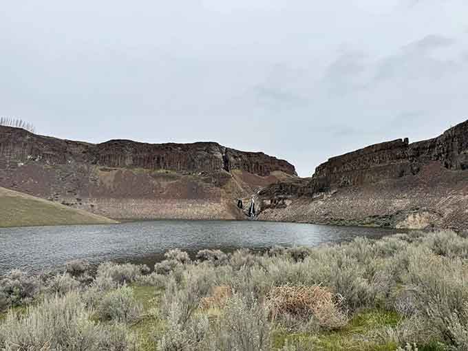 Peaceful waters nestle between canyon walls, offering hikers a rewarding view that's worth every dusty step.
