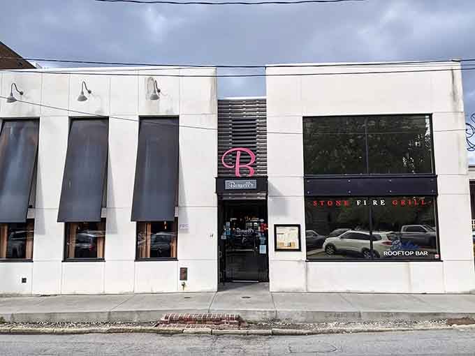 Clean modern lines and that rooftop bar hint at downtown sophistication where stone-fired flavors meet urban energy beautifully.