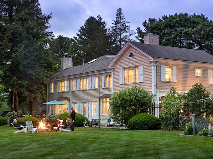 Glowing windows and a crackling fire pit create the coziest New England evening imaginable.
