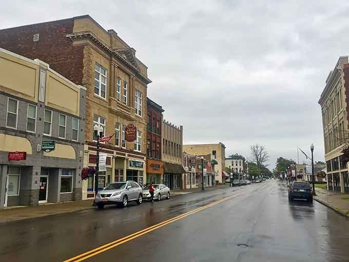 Rain-slicked streets reflect the storefronts on a quiet day when the town takes a collective breath between busy moments.
