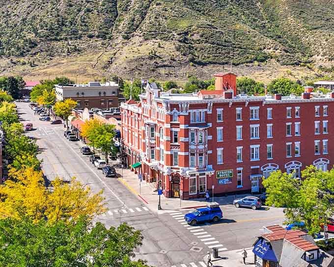 Red brick buildings line the boulevard where autumn trees add golden accents to the historic streetscape.