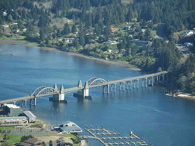 The graceful bridge spans blue water connecting communities, proving engineering can be both functional and absolutely gorgeous.