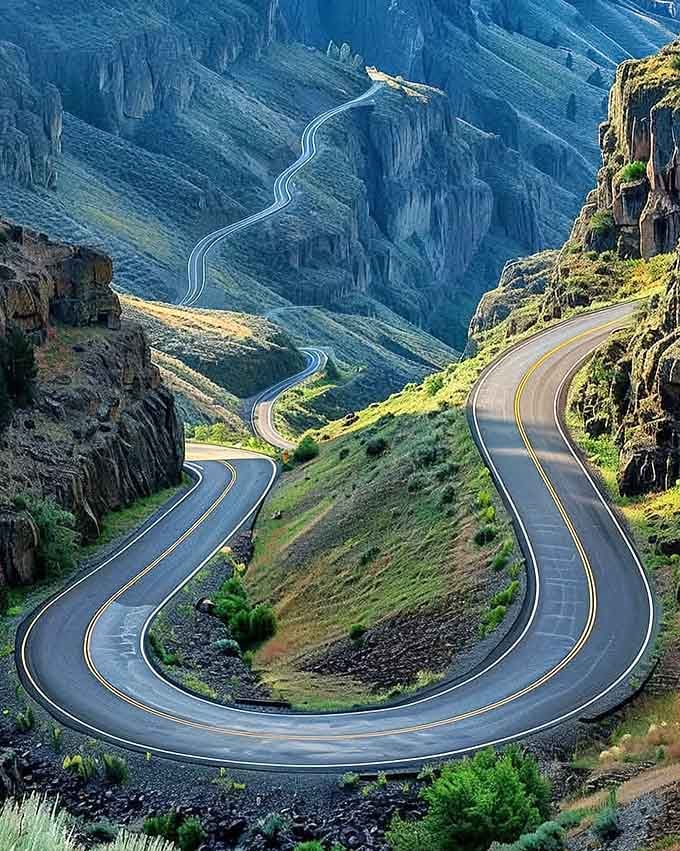 These hairpin curves stack like a roller coaster through the canyon, each switchback more dramatic than the last.