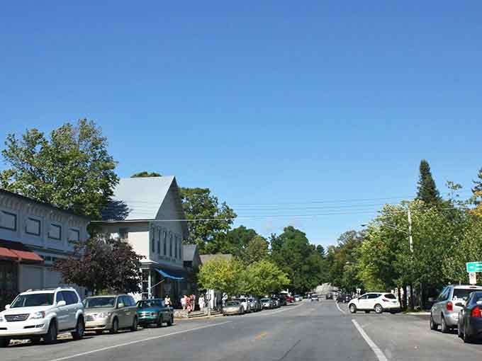 Tree-lined streets lead toward the water where boats rest peacefully after a day on the lake.