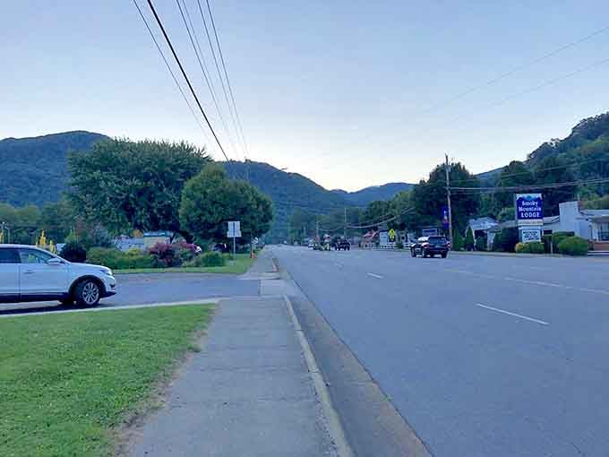 Mountain town streets rest quietly in evening light, with peaks standing guard like protective giants over this peaceful valley.