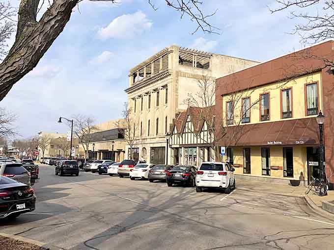 Tudor-style facades and cream-colored buildings line streets where parking is easy and stress is optional.