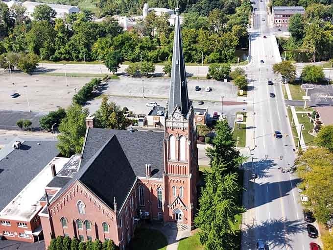 That soaring brick steeple reaches skyward like it's trying to high-five the clouds on a beautiful Pennsylvania afternoon.