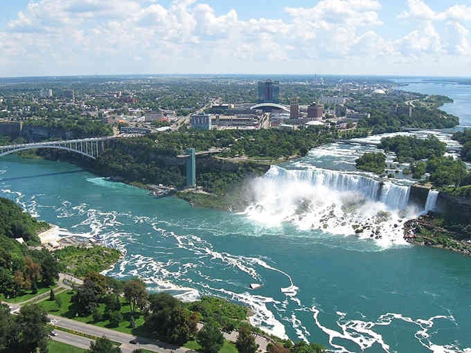 Niagara Falls thunders magnificently from this aerial view, reminding you that living near natural wonders doesn't require winning the lottery.