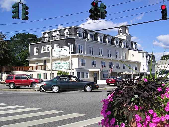 The grand hotel commands attention like a dowager empress, graciously presiding over this charming seaside community with timeless elegance.