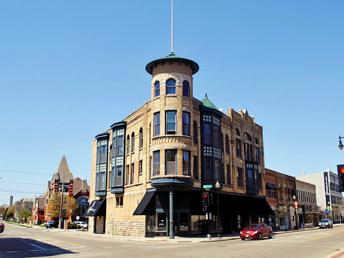 Oshkosh's corner tower building commands attention with its unique turret, blending old-world charm with contemporary street life.