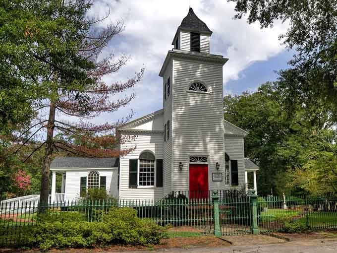 This charming white church with its bright red door welcomes visitors like an old friend's embrace.