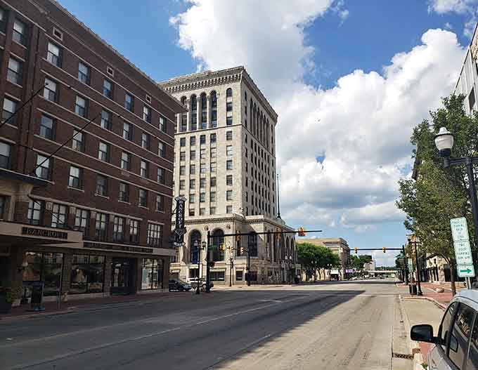 Modern meets traditional on streets where construction workers in neon vests pass businesspeople, everyone building tomorrow together without the usual big-city attitude.