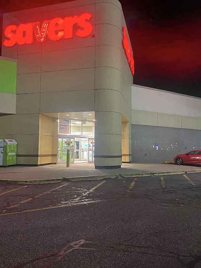 The glowing red Savers sign at dusk looks almost theatrical, like a Broadway marquee for the thrift store set.