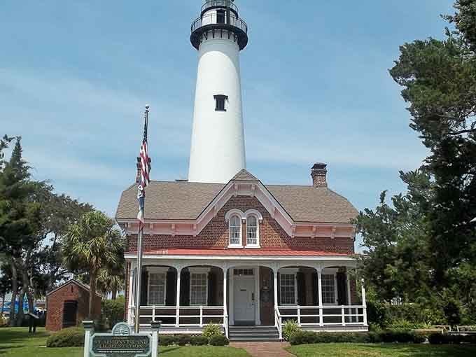 The historic lighthouse stands sentinel over the island, guiding ships and tourists alike to coastal paradise.