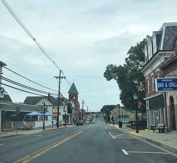 That charming bell tower watches over quiet streets where American flags flutter and life moves at exactly the right speed.