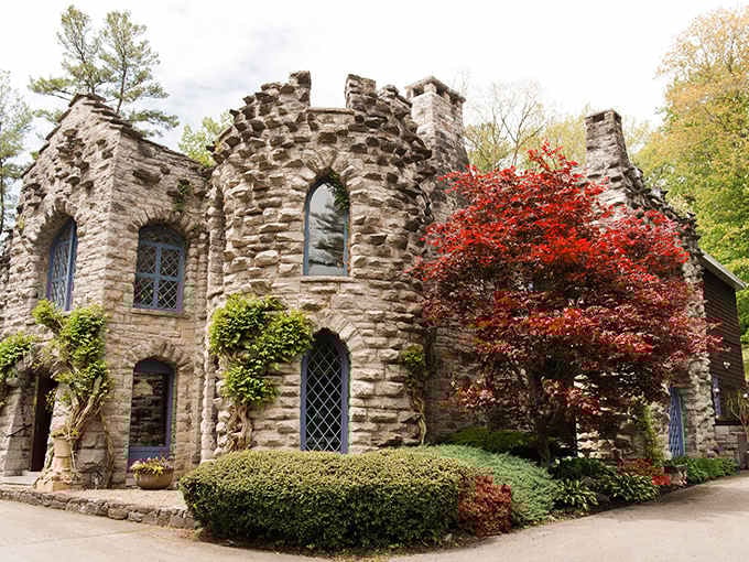 Autumn's crimson leaves against ancient stone walls create a scene straight from a Brothers Grimm illustration.