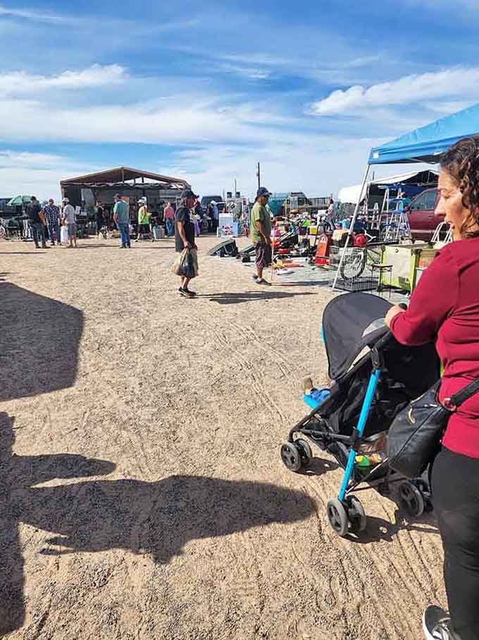 Families strolling past vendor stalls under big skies embody the timeless appeal of community gathering and weekend traditions.
