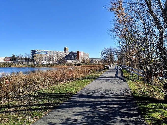 Industrial heritage meets waterfront serenity on this perfect walking path where history whispers through the autumn breeze.