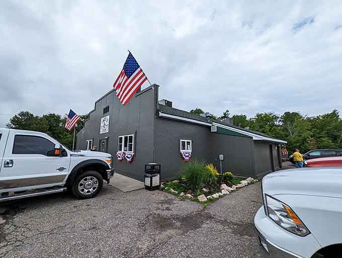 The gray exterior and full parking lot tell you everything: locals know this unassuming building hides extraordinary dining experiences.