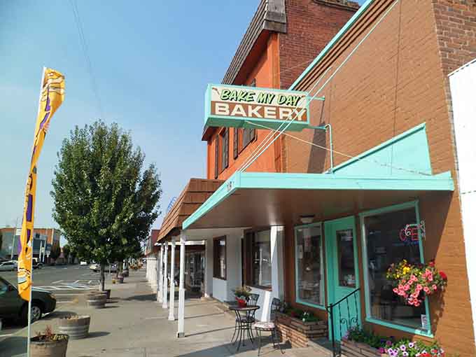 Turquoise awnings pop against brick facades like a splash of optimism on a perfectly ordinary Tuesday afternoon.