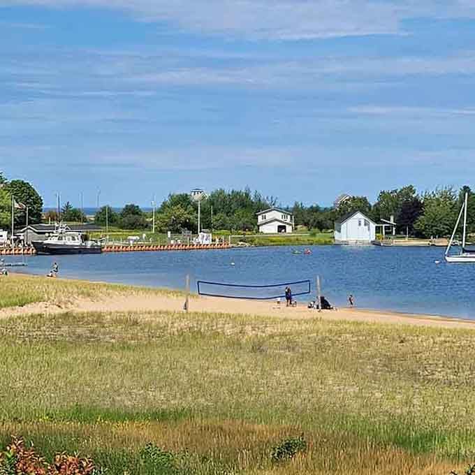 Sandy beach meets calm waters where families gather to enjoy simple pleasures under the vast Upper Peninsula sky.