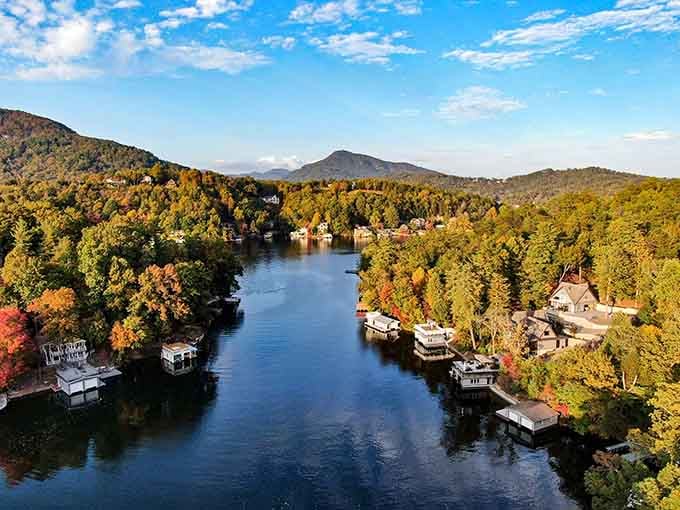 Autumn paints the shoreline in gold and crimson while the water stays impossibly blue and perfectly still.