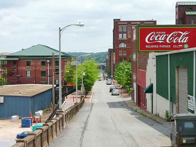 The vintage Coca-Cola sign towers over downtown like a beloved landmark from when soda fountains were the social media.