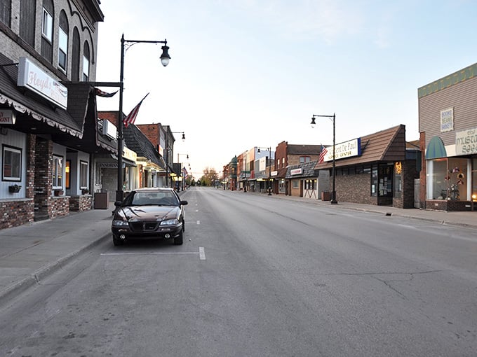 Soft light bathes this quiet main street in a warm glow that makes every storefront look inviting.
