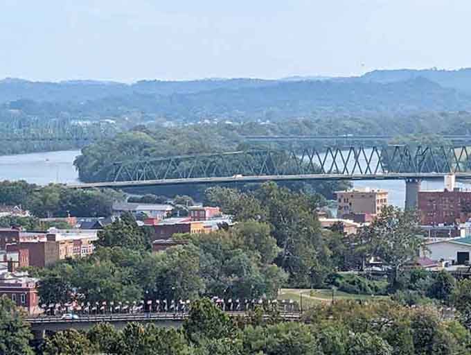 That bridge spans the river like a promise connecting communities where neighbors still know each other's names.