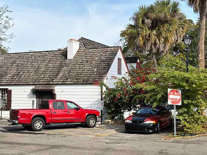 The white clapboard exterior with blooming flowers creates an intimate setting that promises memorable dining experiences.