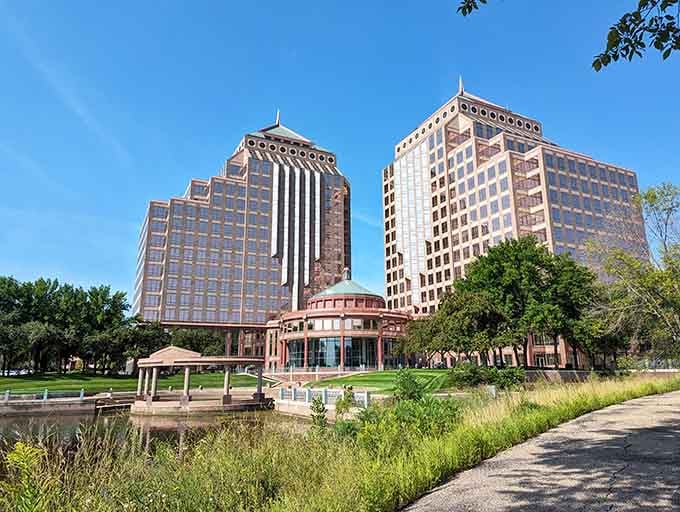 Twin office towers stand like bookends framing a peaceful park where lunch breaks feel like mini-vacations.