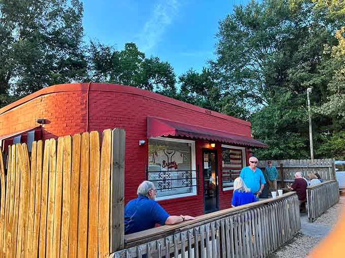 Wooden fence seating and warm glow suggest casual outdoor dining where flavor matters more than fancy presentation.