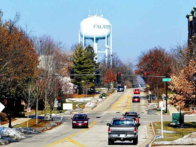 The water tower rises above fall foliage like a postcard from small-town America that never went out of style.