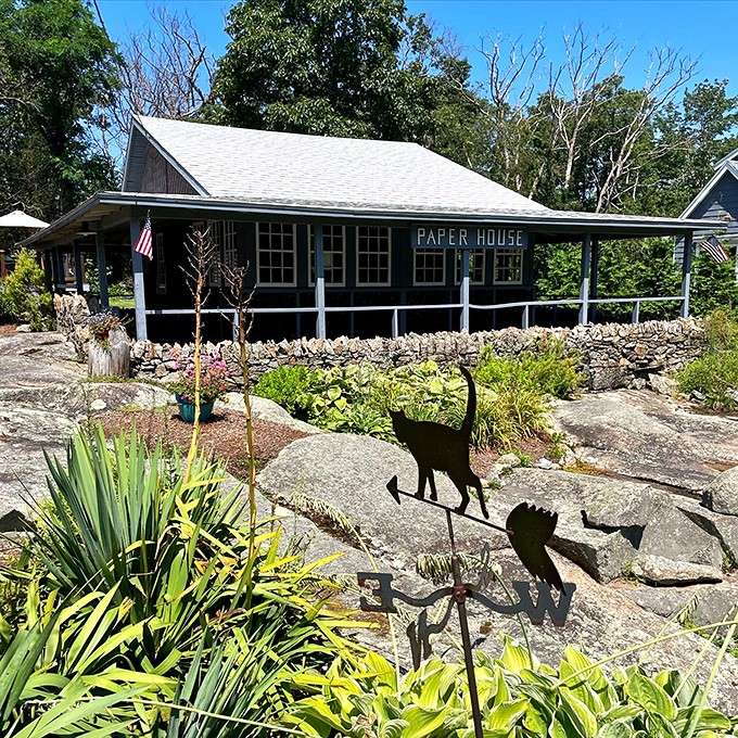 Whimsical cat silhouettes dance across the rock garden, adding playful touches to this wonderfully odd roadside attraction's creative landscaping.